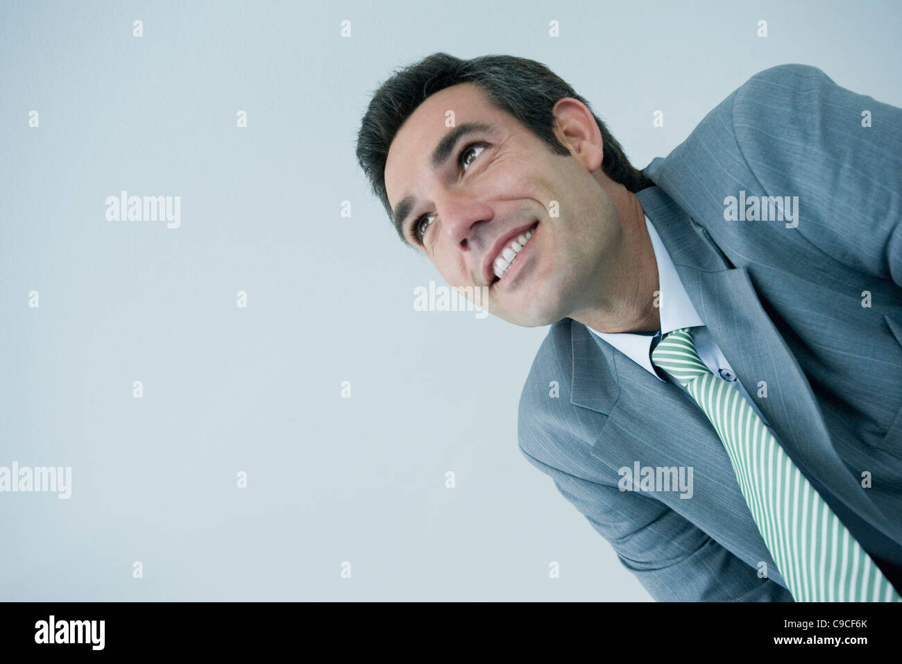 Executive smiling, low angle view Stock Photo - Alamy
