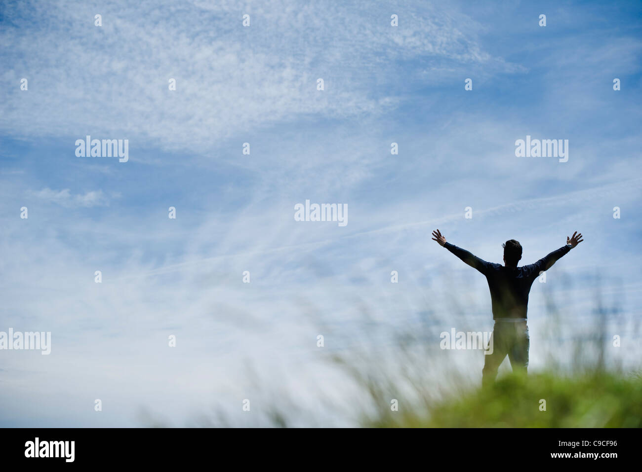 Man with arms up in nature, rear view Stock Photo - Alamy