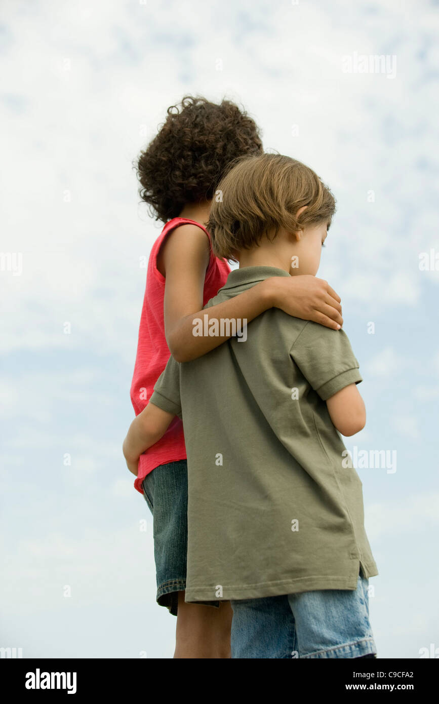Young siblings standing together outdoors Stock Photo - Alamy
