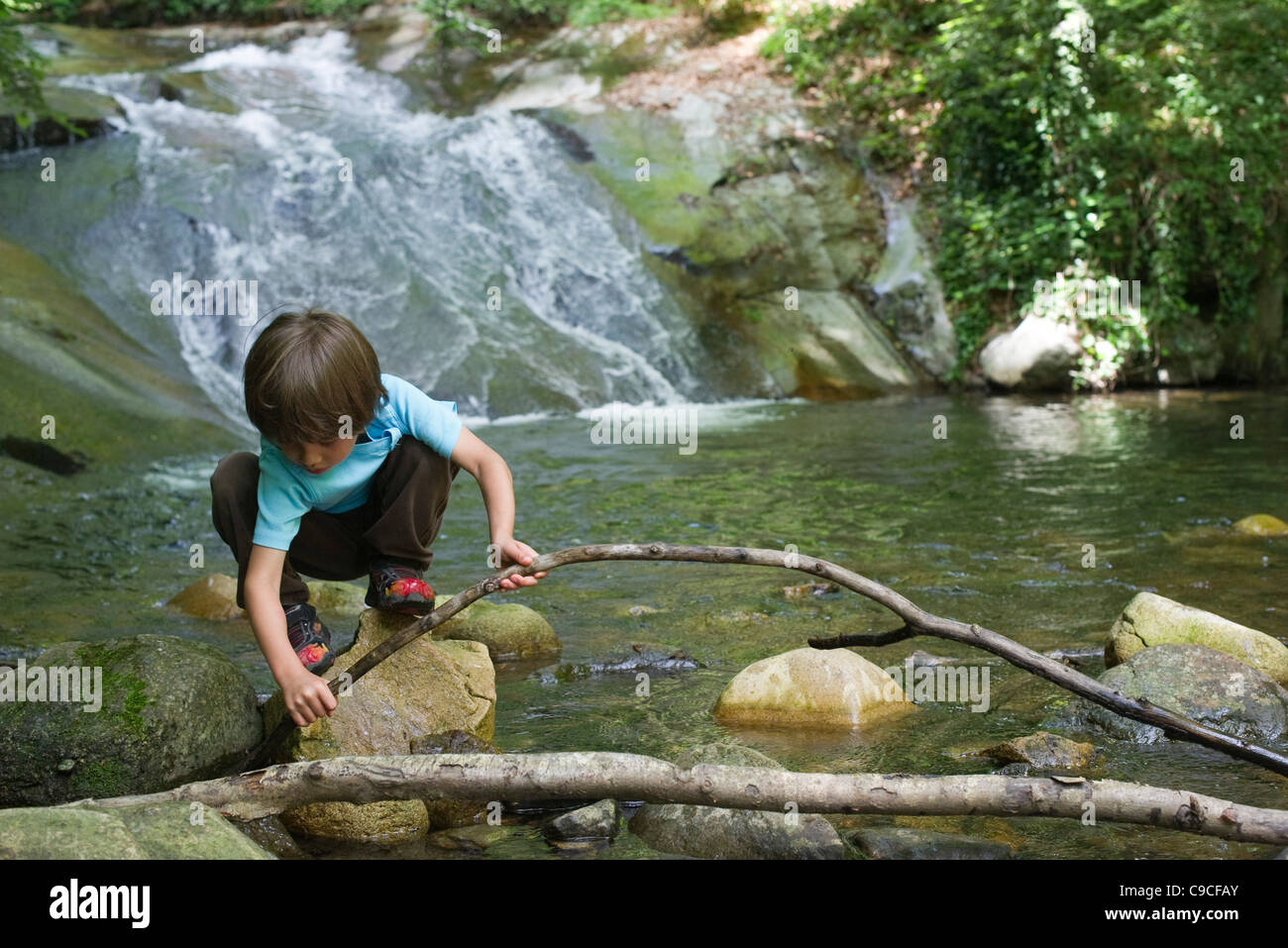 Young boy exploring nature Stock Photo - Alamy