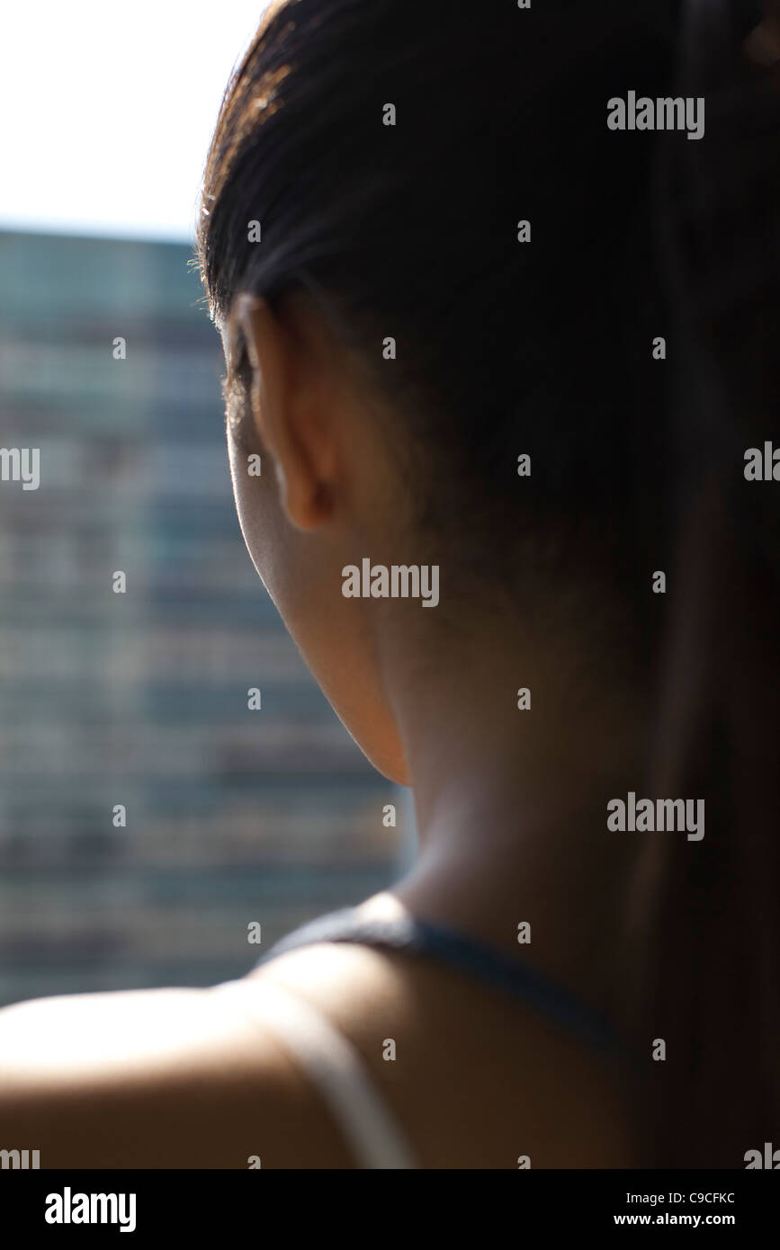 Woman by window, rear view, backlit Stock Photo - Alamy
