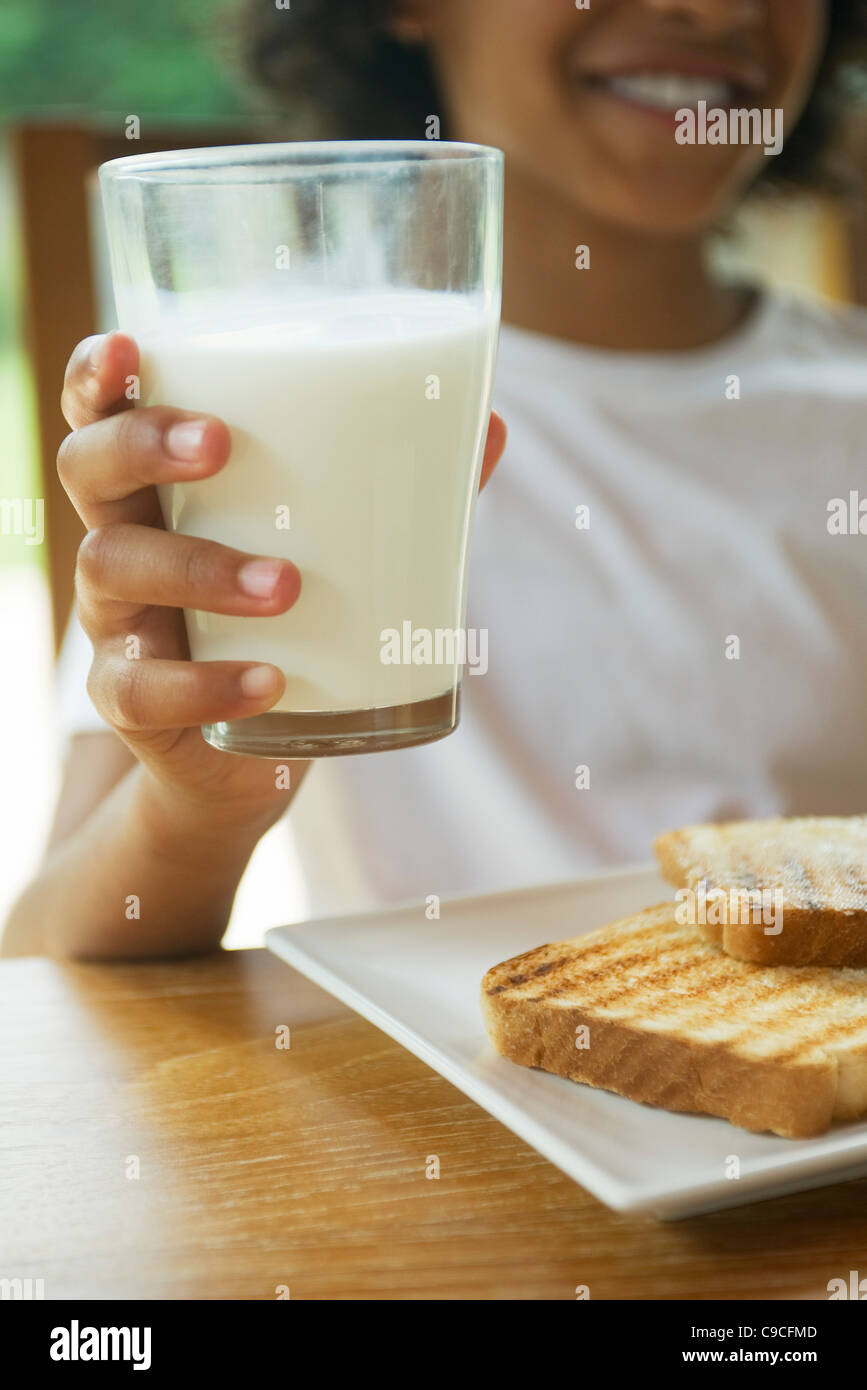 Child holding glass of milk, cropped Stock Photo - Alamy