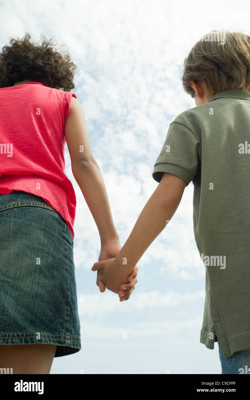 Children holding hands, rear view Stock Photo - Alamy