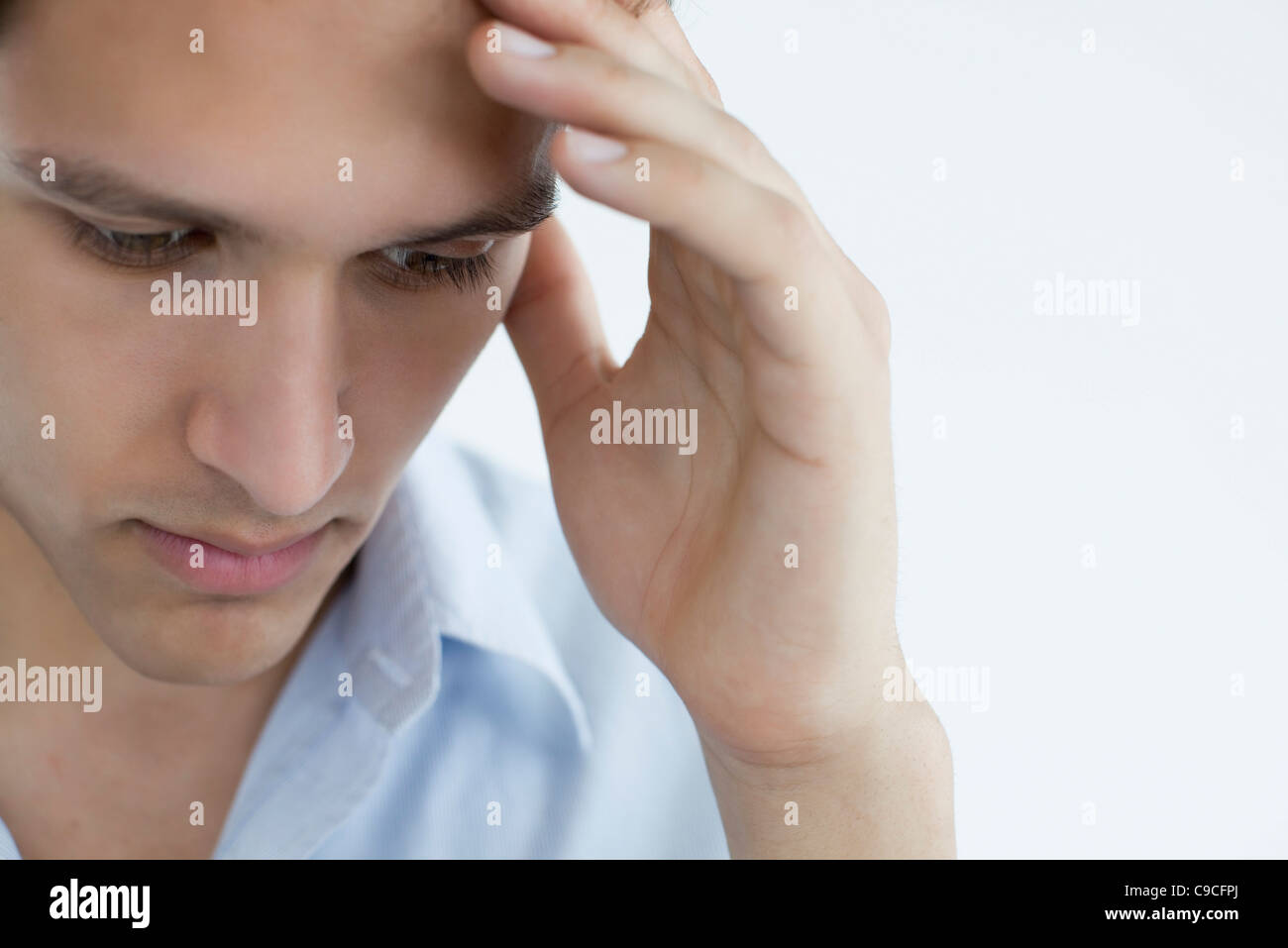 Man with hand on forehead Stock Photo - Alamy