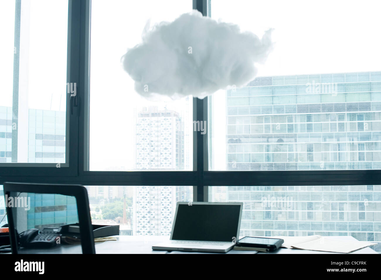 Laptop computer on desk, cloud above laptop computer Stock Photo - Alamy