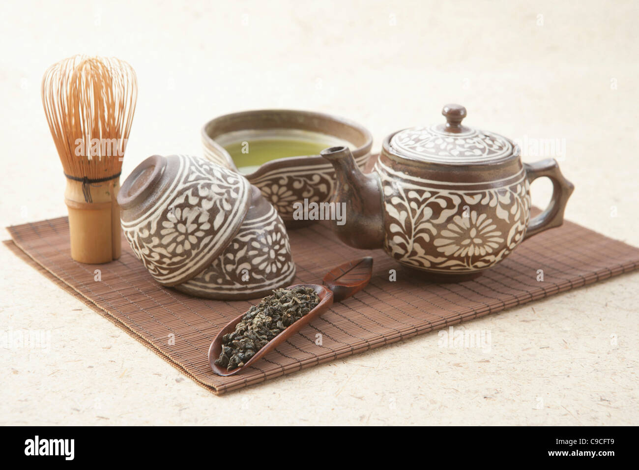 Classical tea set with green tea leaves Stock Photo - Alamy