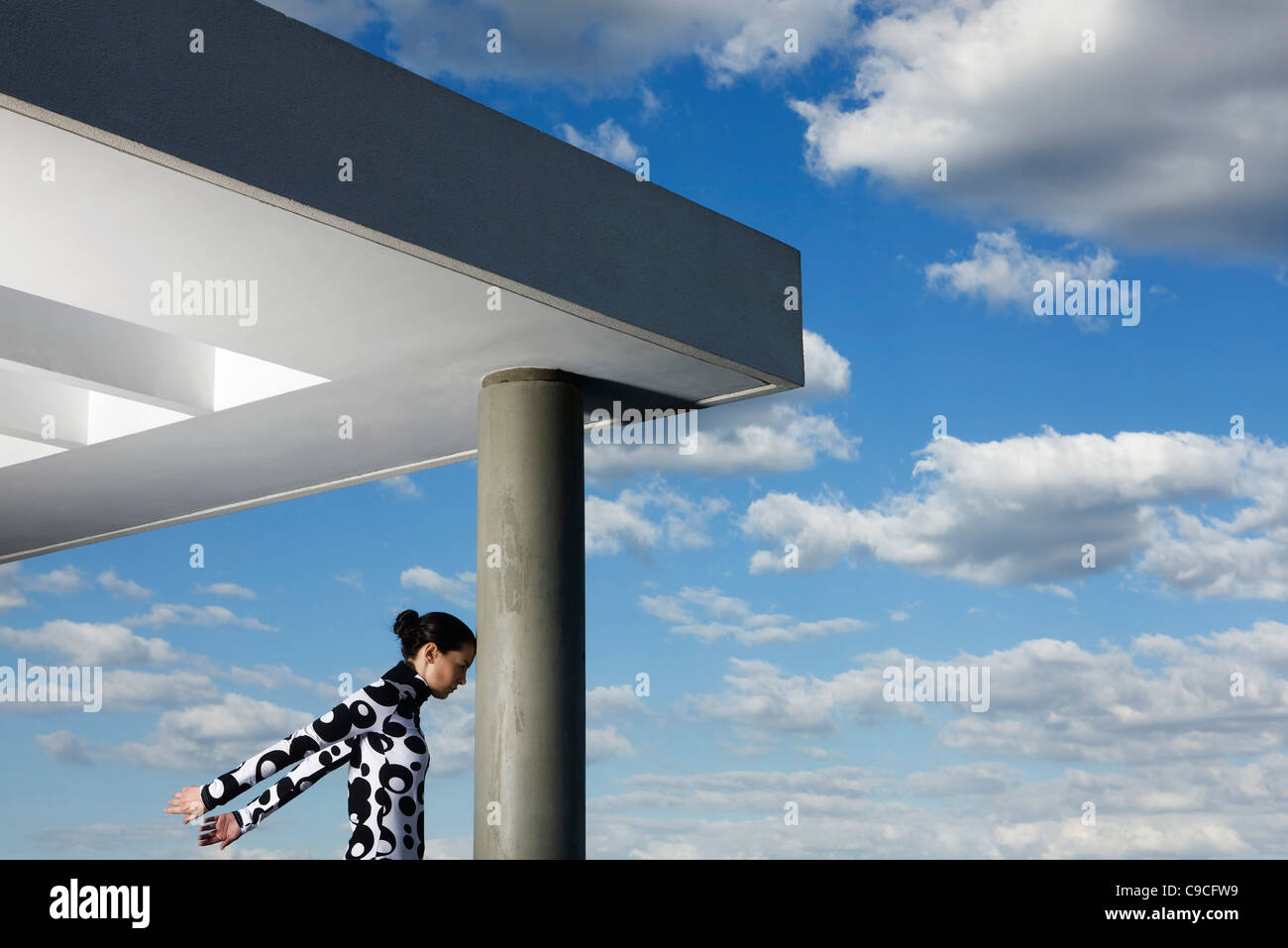 Young woman pressing forehead against portico column Stock Photo - Alamy
