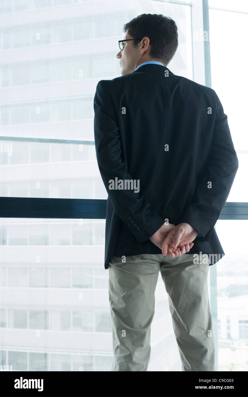 Executive looking out window Stock Photo - Alamy