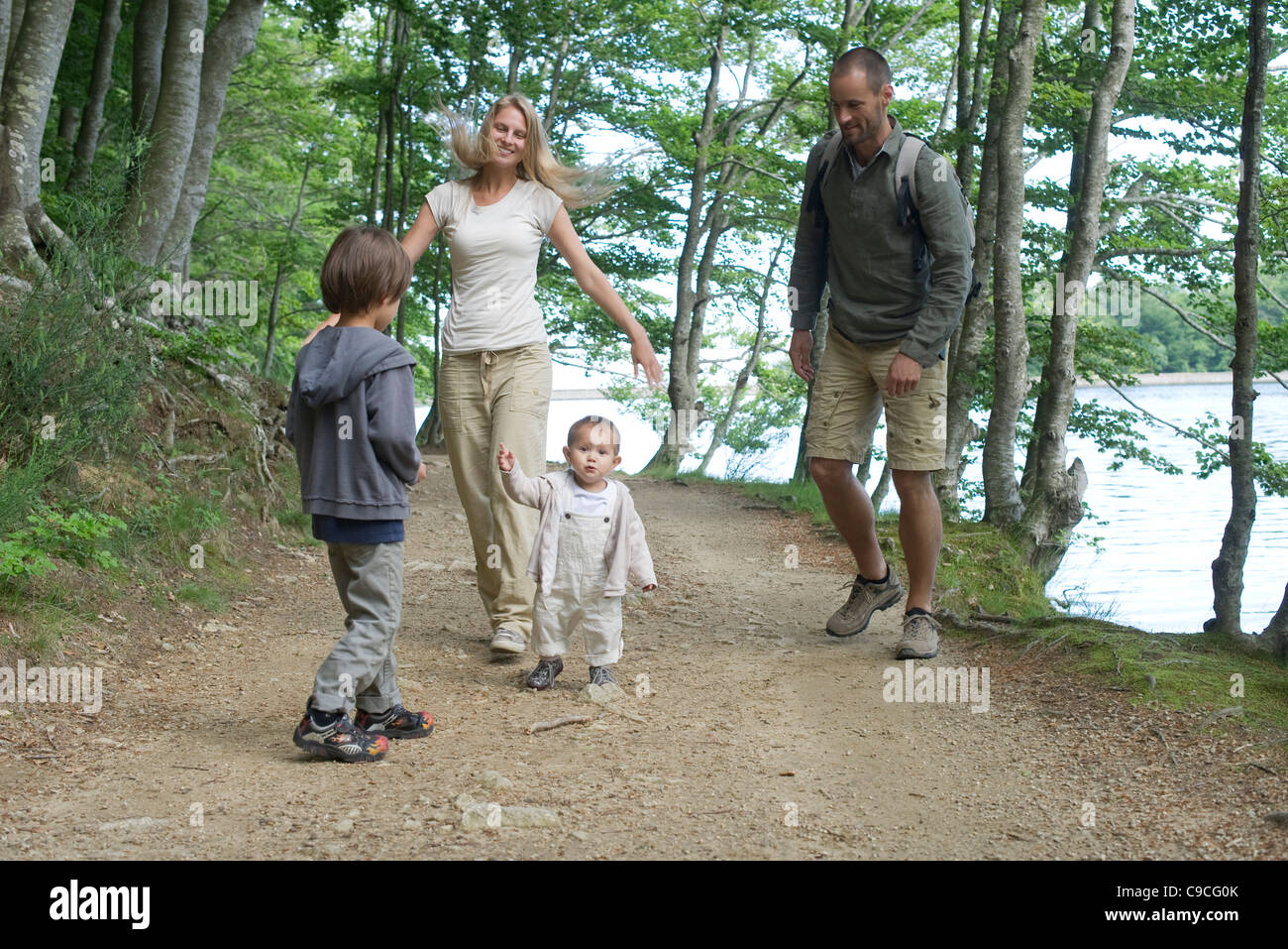 Family hiking in woods Stock Photo - Alamy