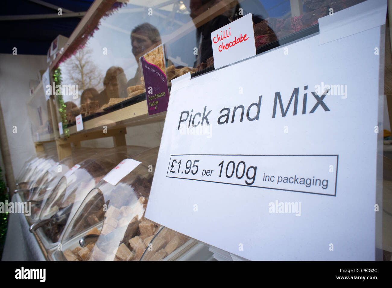 People queuing reflected in an outdoor pick and mix stall Stock Photo ...
