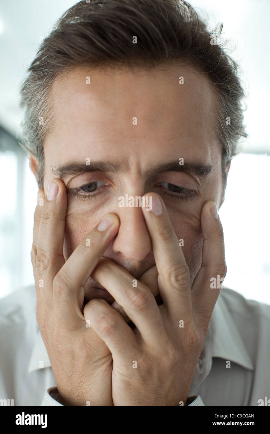 Man with hands covering face Stock Photo - Alamy