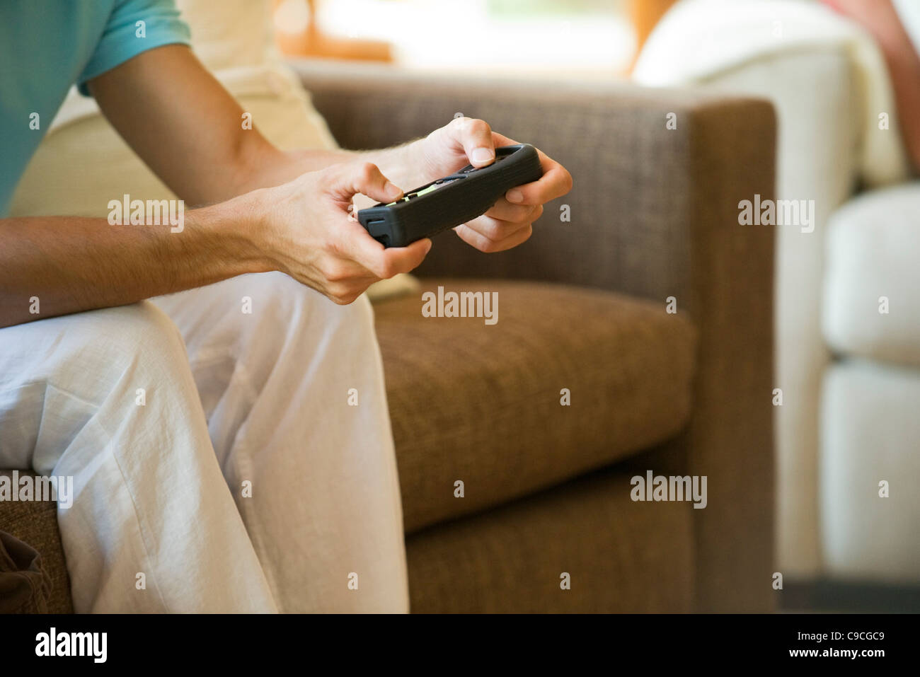 Man playing video game using wireless controller, cropped Stock Photo ...