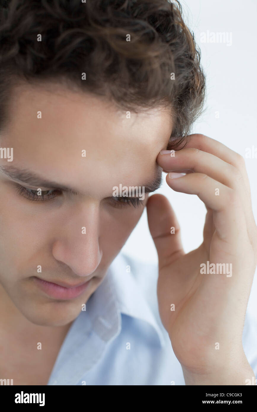 Man with hand on temple Stock Photo - Alamy