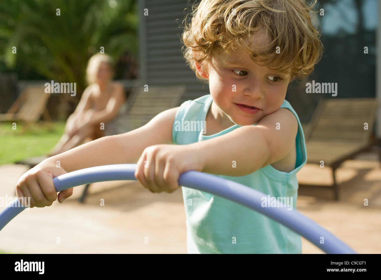 Little boy playing with plastic hoop Stock Photo - Alamy