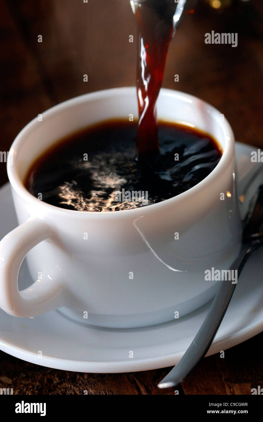 Hot coffee pouring into cup Stock Photo - Alamy