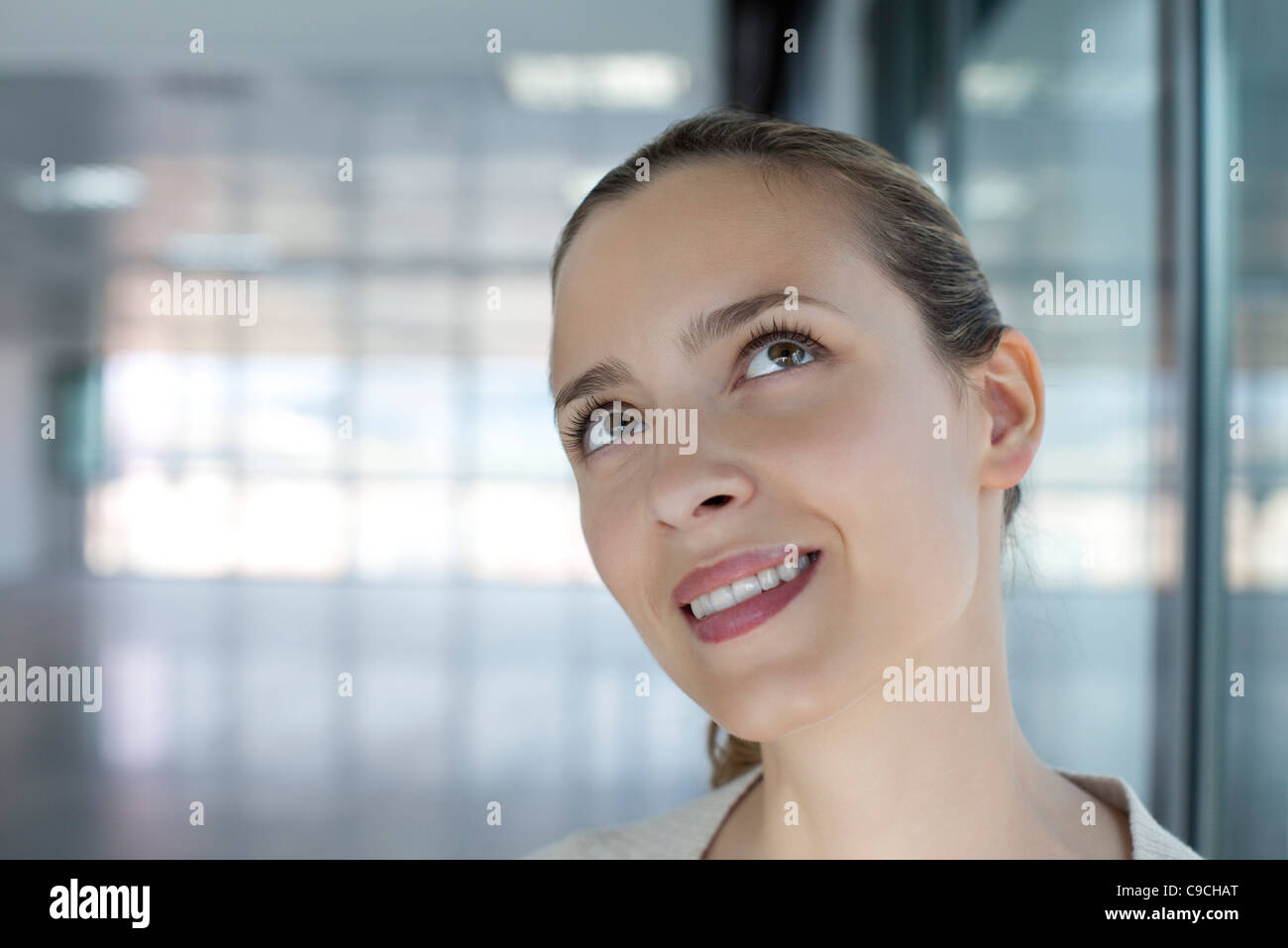 Woman looking up with head tilted Stock Photo - Alamy