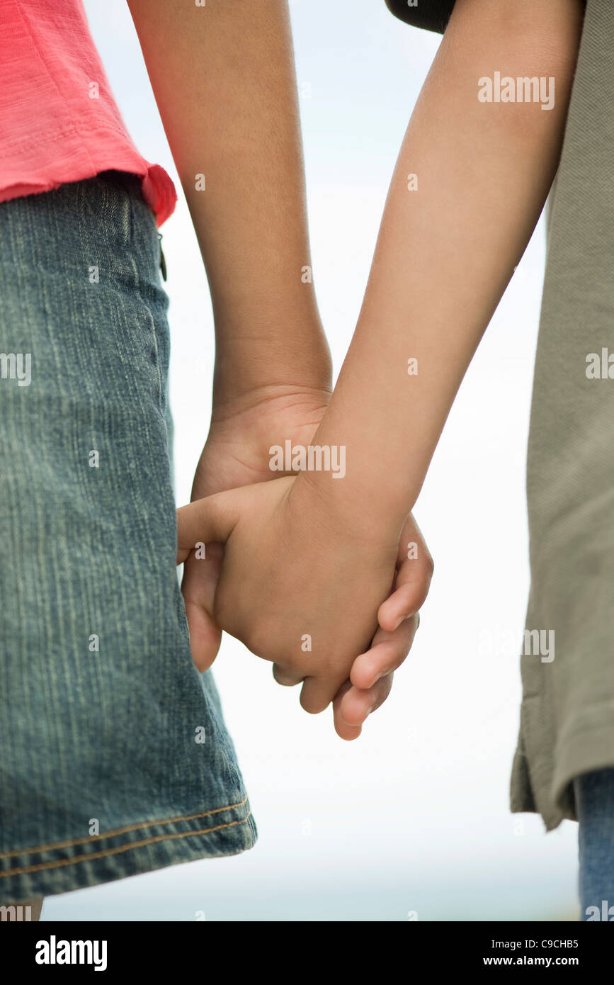 Children holding hands, close-up Stock Photo - Alamy