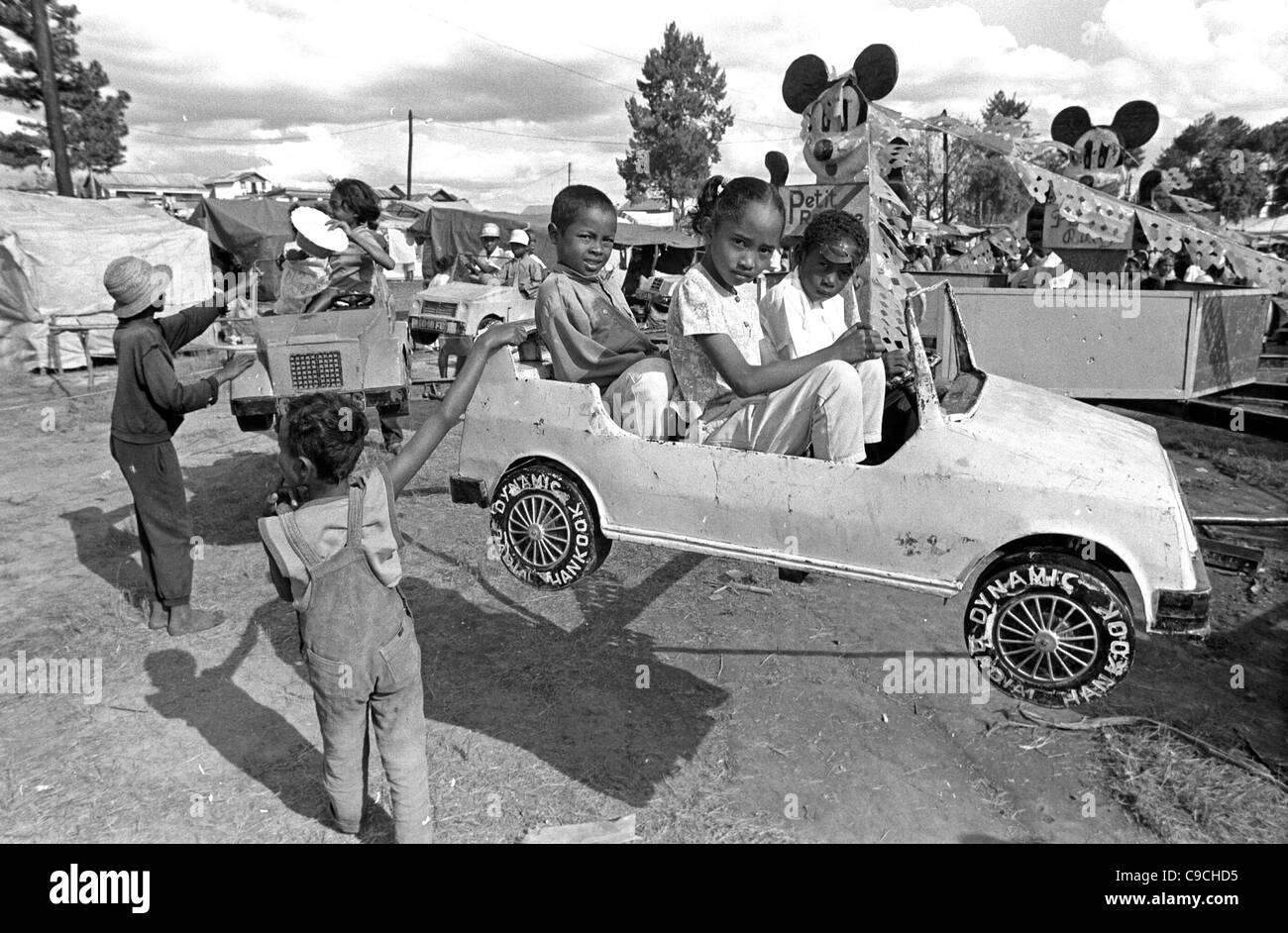 Children on a roundabout at a fun fair Black and White Stock Photos ...