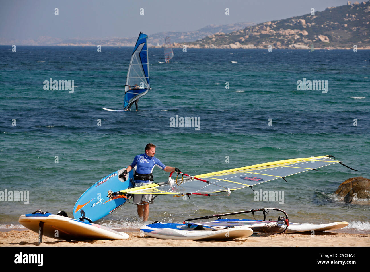 Surfing at Porto Pollo beach, Sardinia, Italy Stock Photo - Alamy