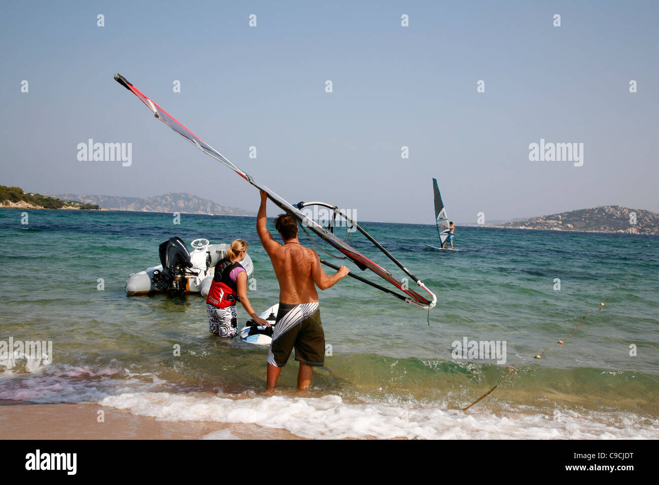Surfing at Porto Pollo beach, Sardinia, Italy Stock Photo - Alamy