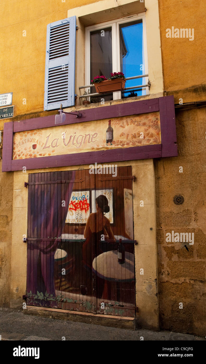 A wall mural of a lady in a cafe as seen from outside the window Stock ...