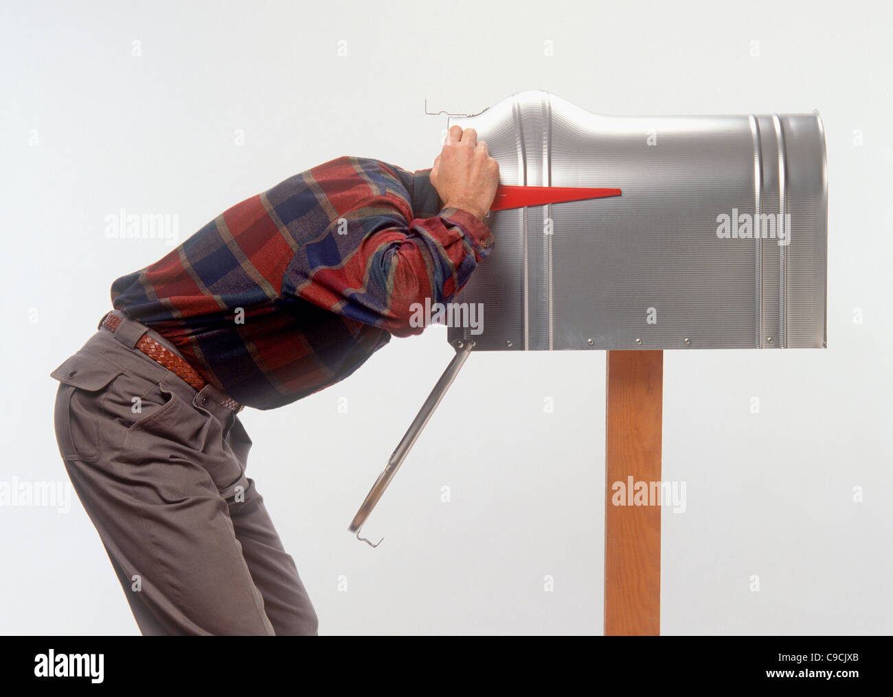 man leaning over with head in over-sized mailbox Stock Photo - Alamy
