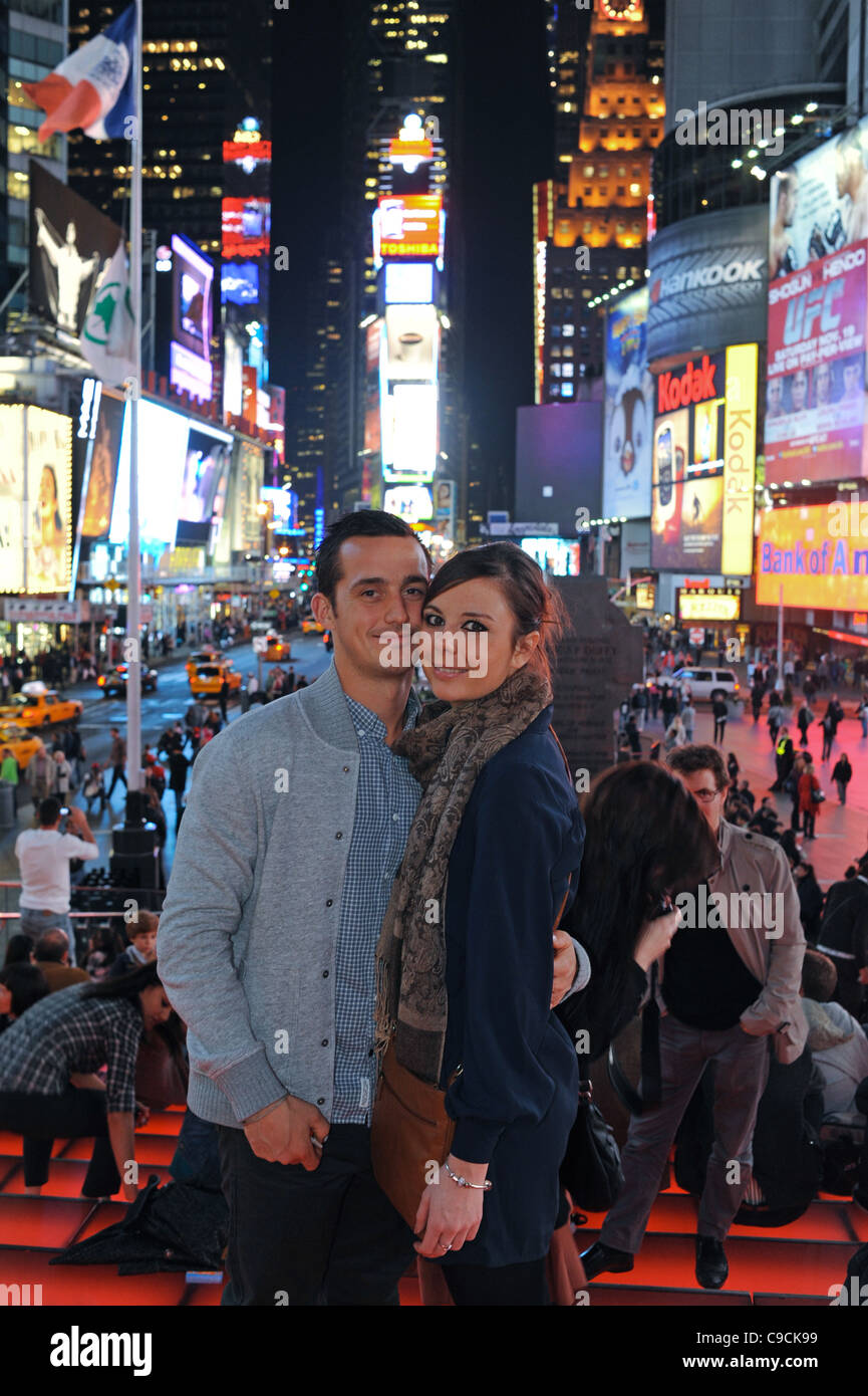 Young attractive couple kissing at night in Times Square Manhattan New ...