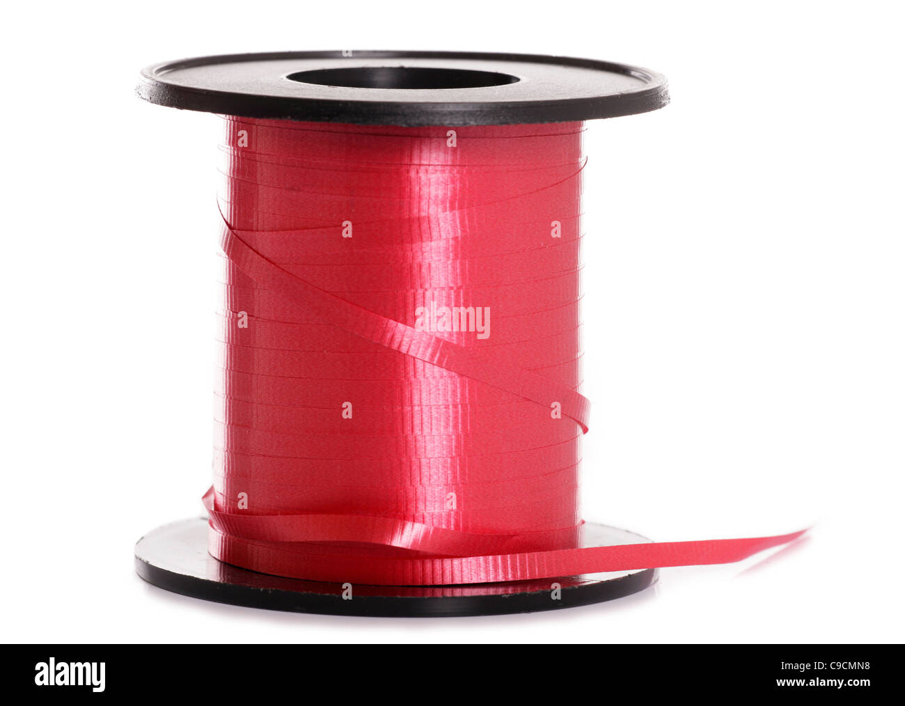Red ribbon on a roll studio cutout Stock Photo - Alamy