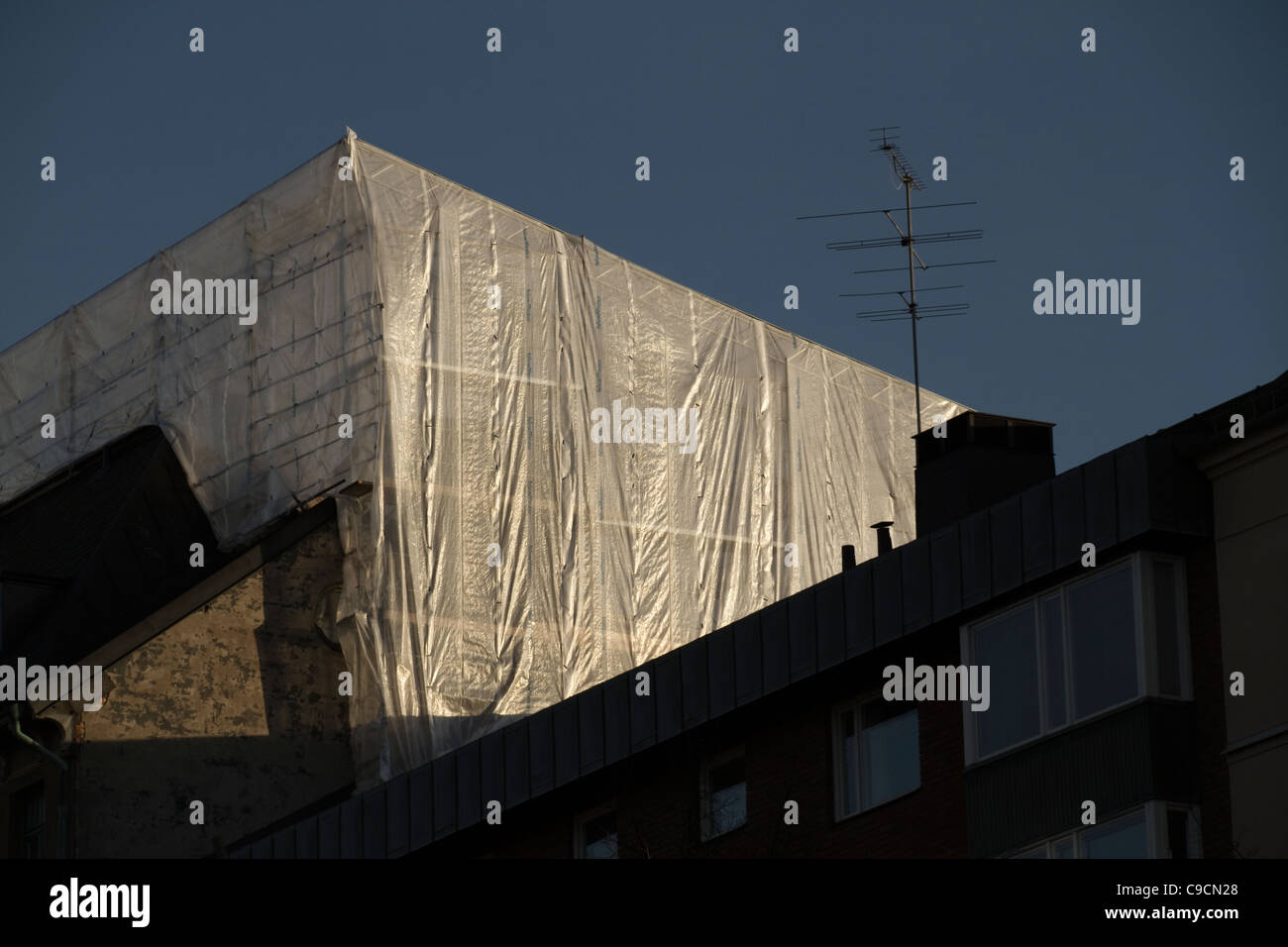 Plastic sheeting covering building at sunset Stock Photo - Alamy