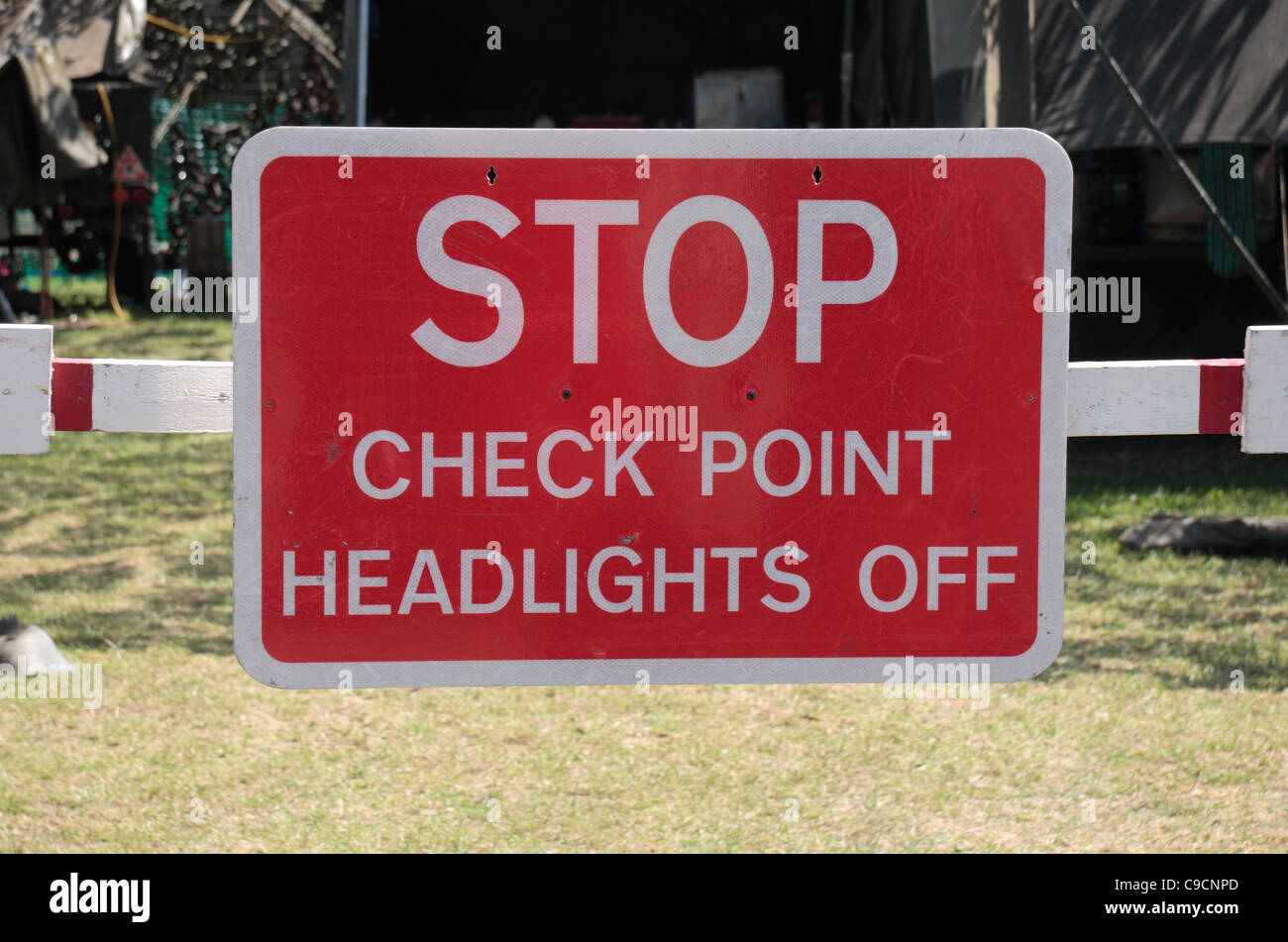 A Stop Check Point sign attached to a raising gate arm at the 2011 War ...