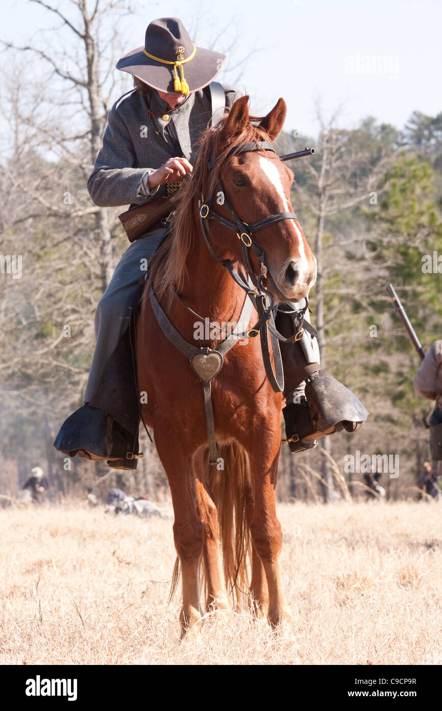 Cavalry soldier riding a horse in battle at a civil war reenactment ...