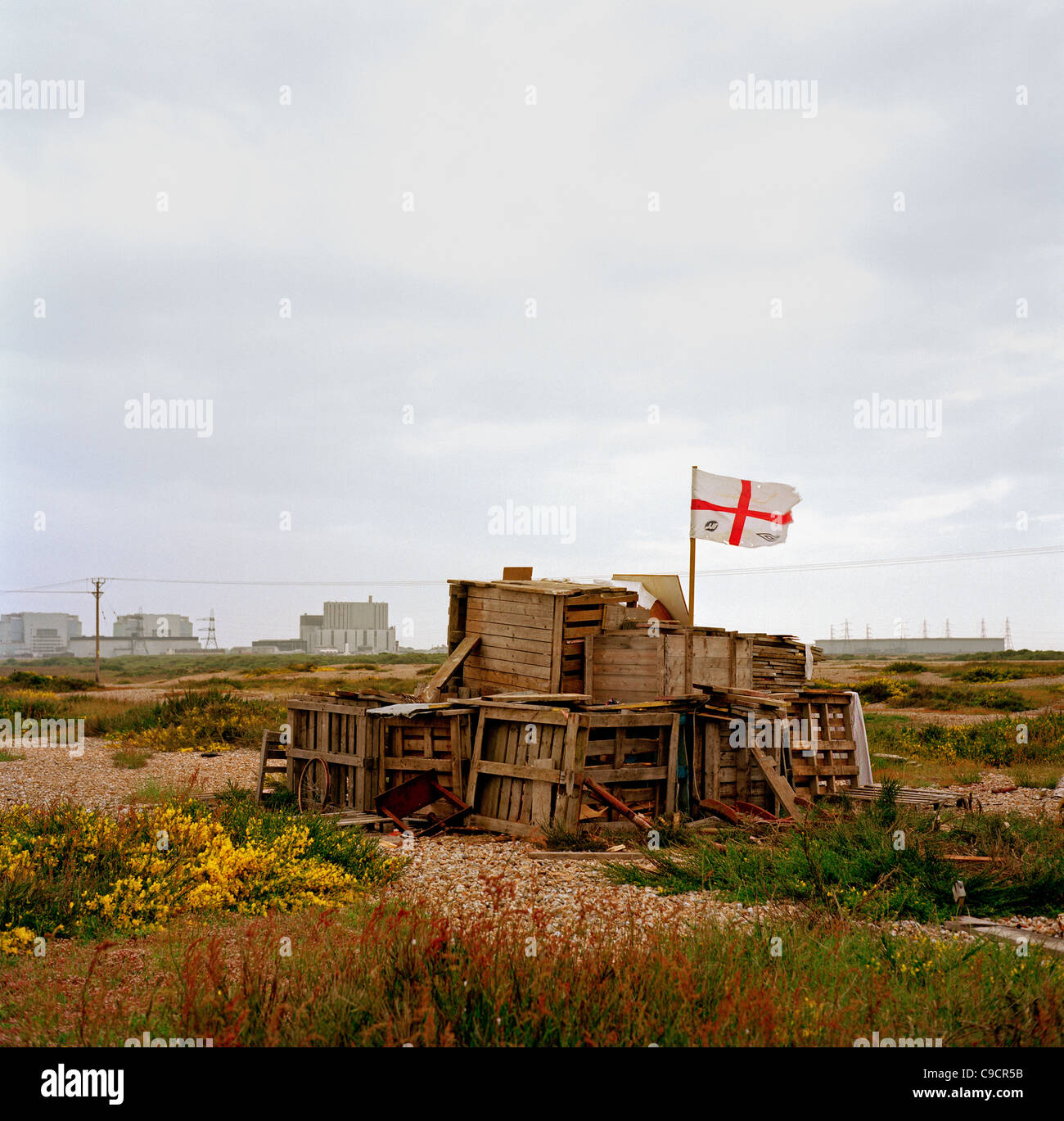 Self-built wooden shed with English flag on open field in Dungeness ...