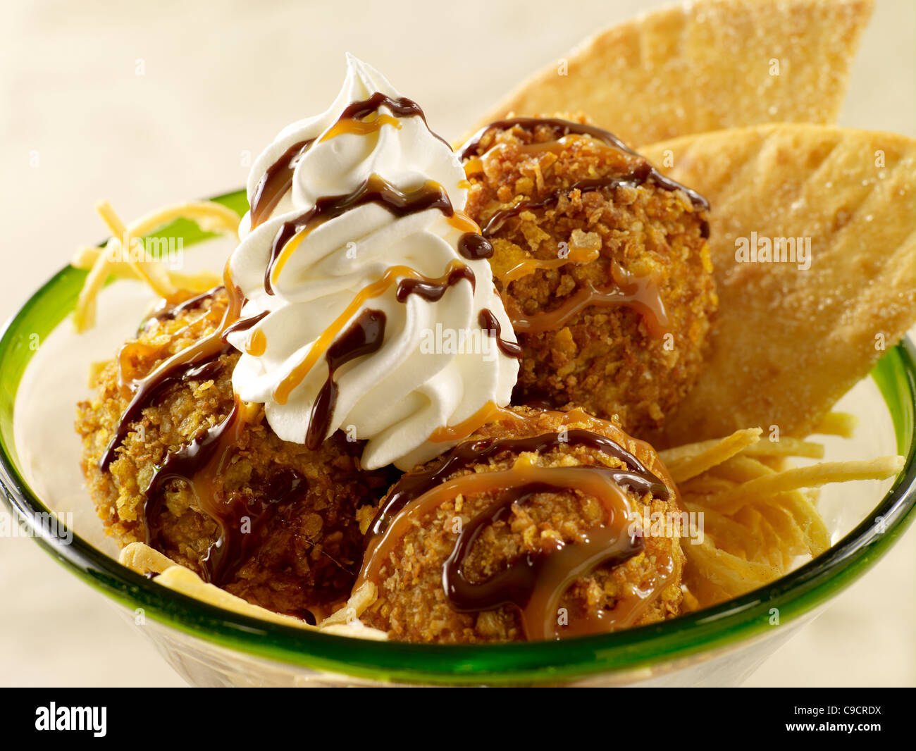 Deep fried ice cream sprinkled with chocolate and caramel sauce and ...