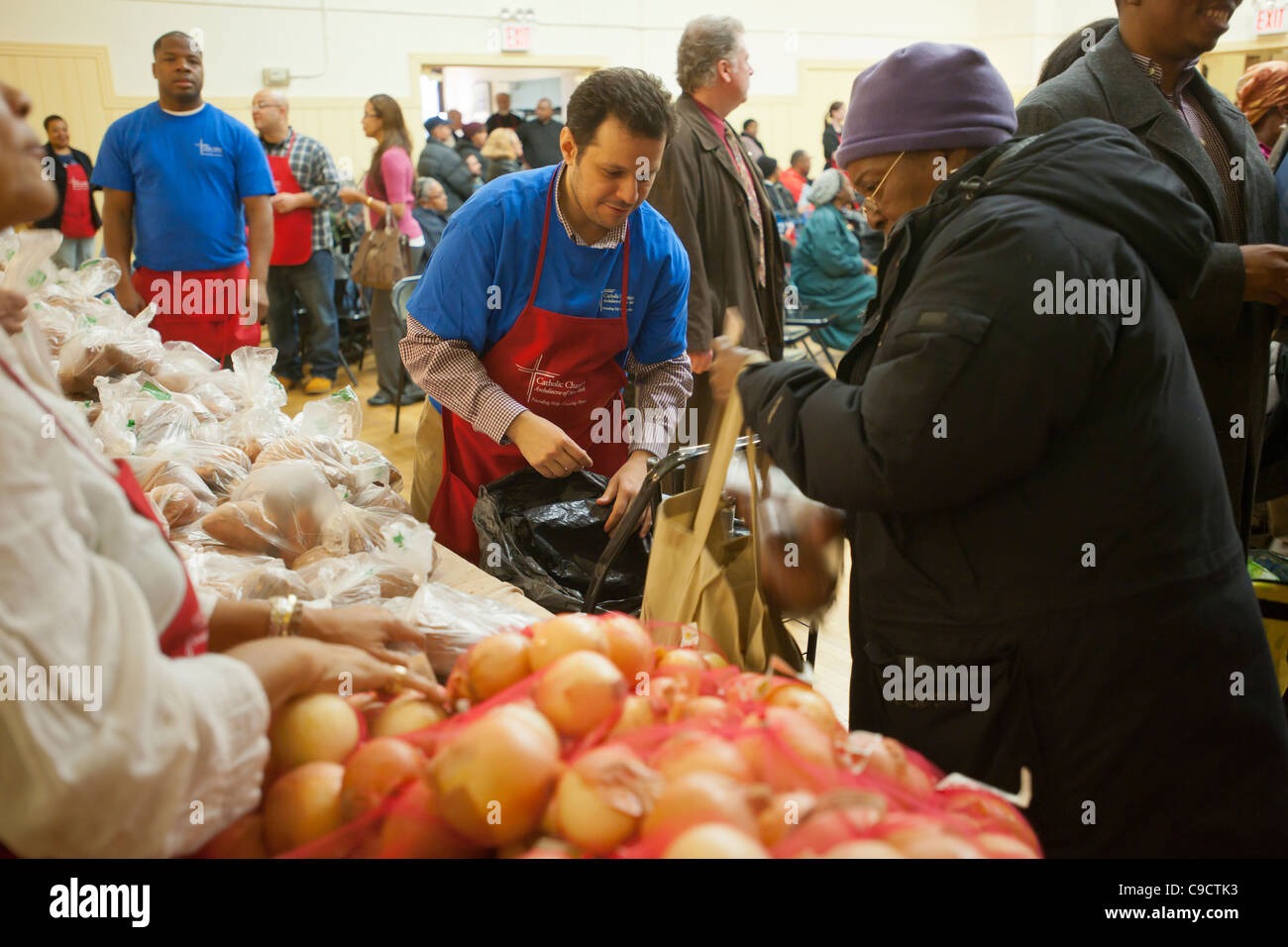 Volunteers distribute turkeys, stuffing and all the other "fixin's" for ...