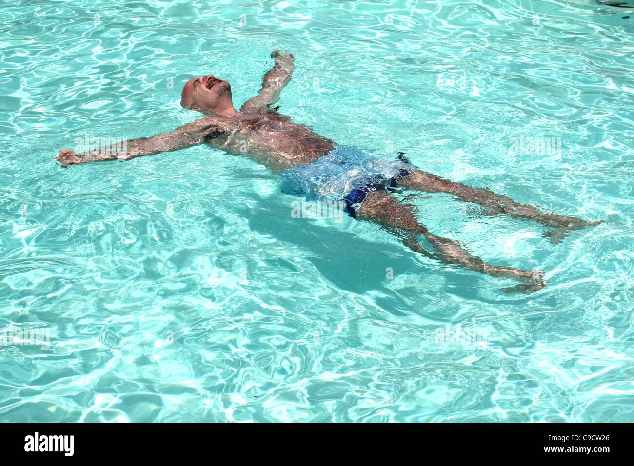 Man relaxing in the swimming pool Stock Photo - Alamy