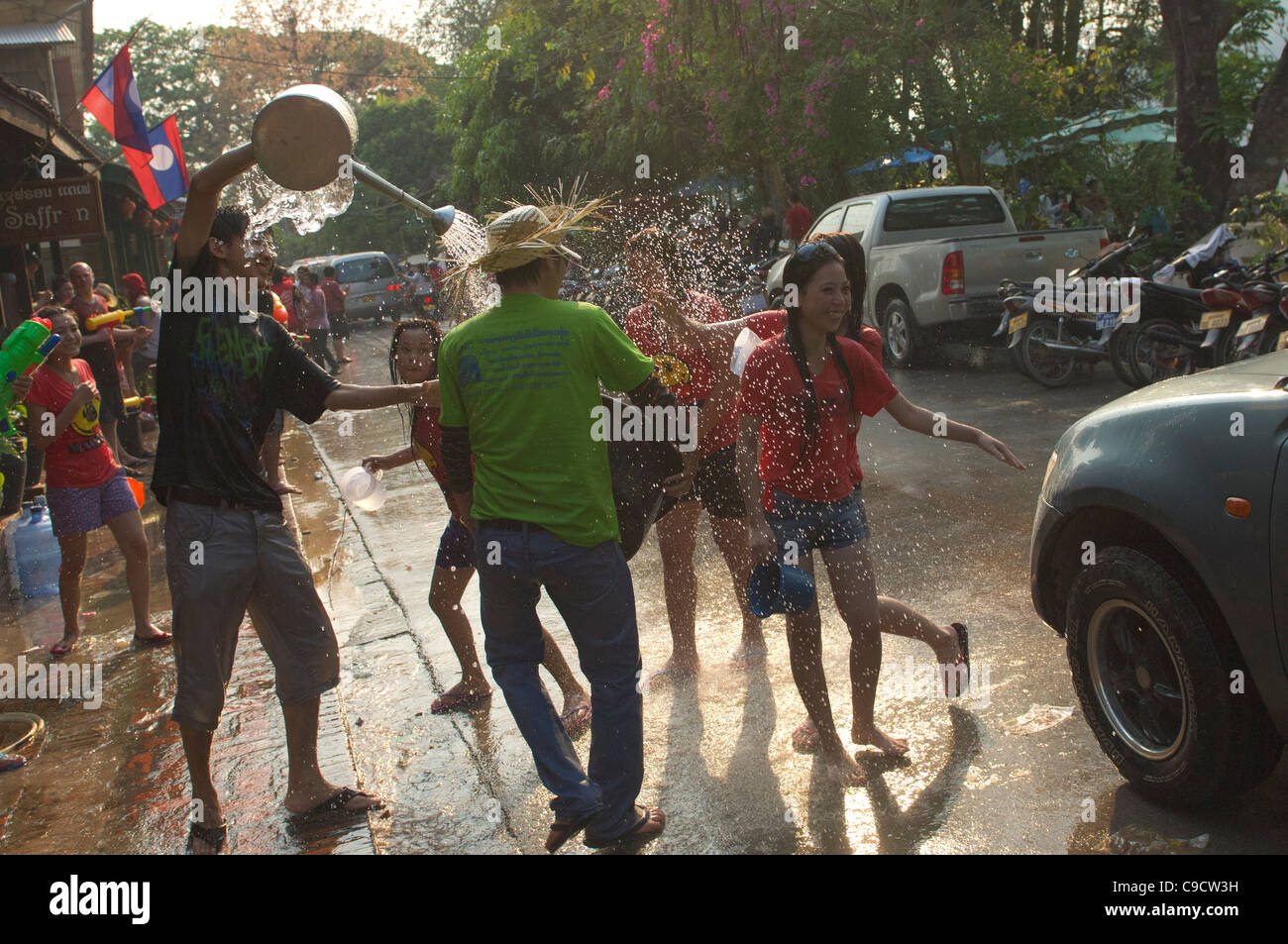 Lao girls being soaked with a watering can during a water-fight to ...