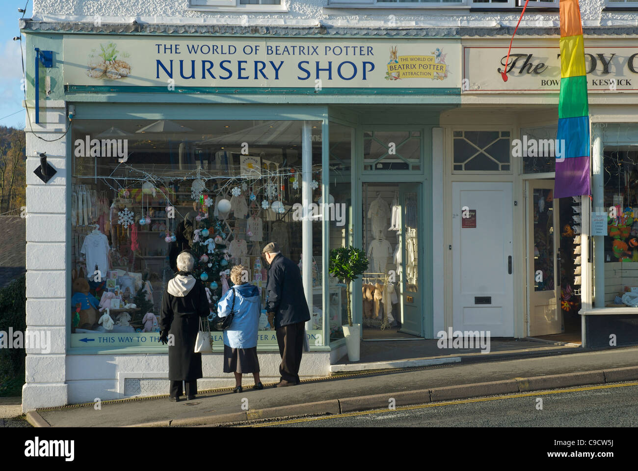 Three people window shopping: World of Beatrix Potter, Nursery Shop ...