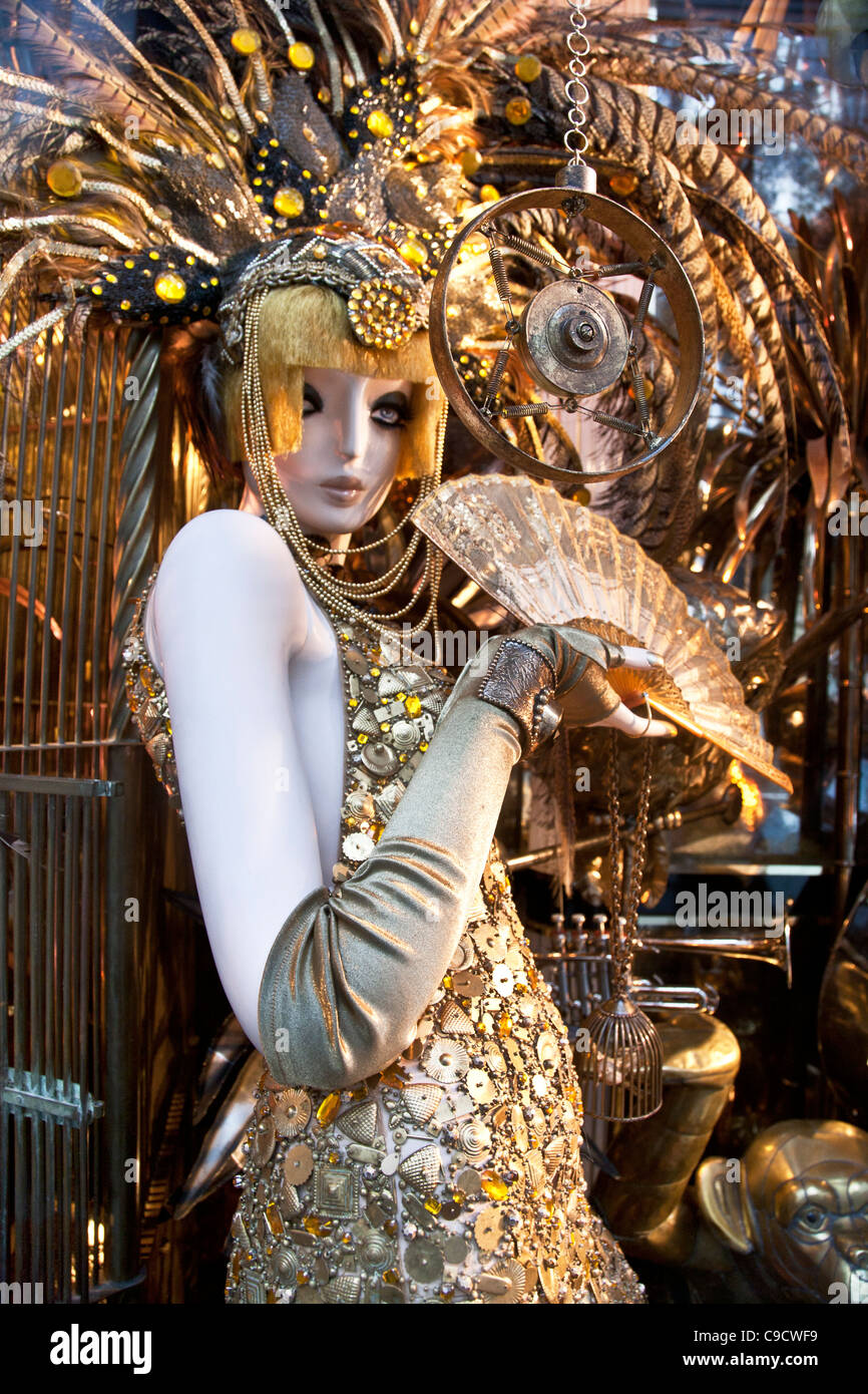 slinky siren mannequin in retro head dress with lace fan sings into ...