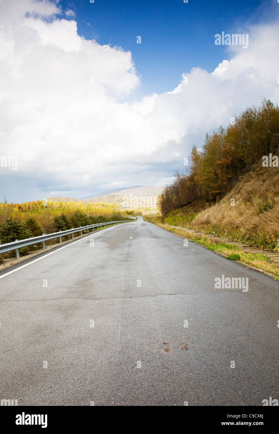 Asphalt freeway and cloudy sky Stock Photo - Alamy