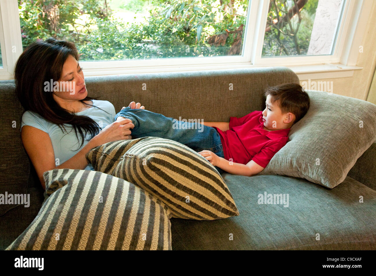 Mother and son talking on the couch Stock Photo - Alamy