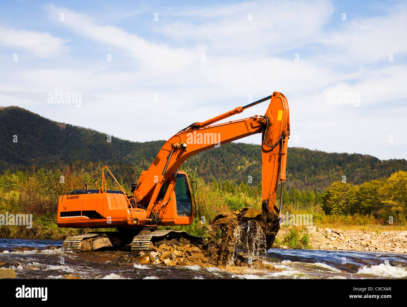 Excavator is dredging sediment mud Stock Photo - Alamy