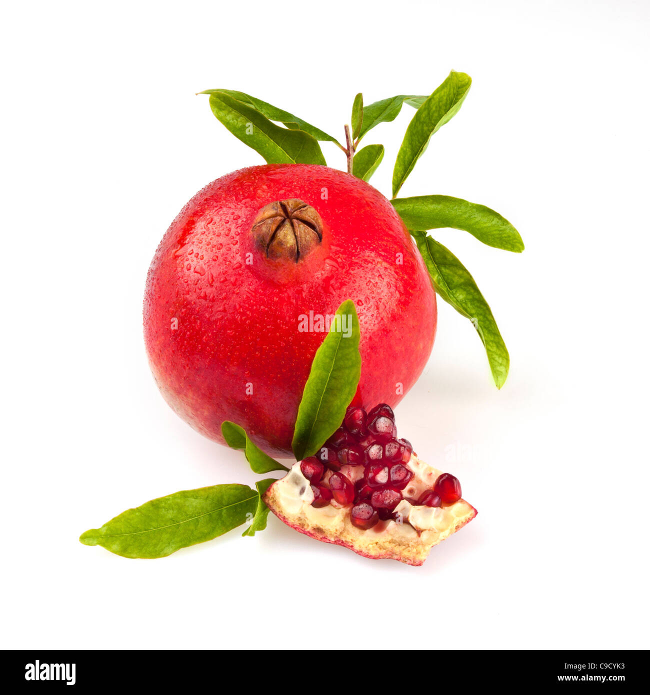 Pomegranate with leaves isolated on white Stock Photo - Alamy