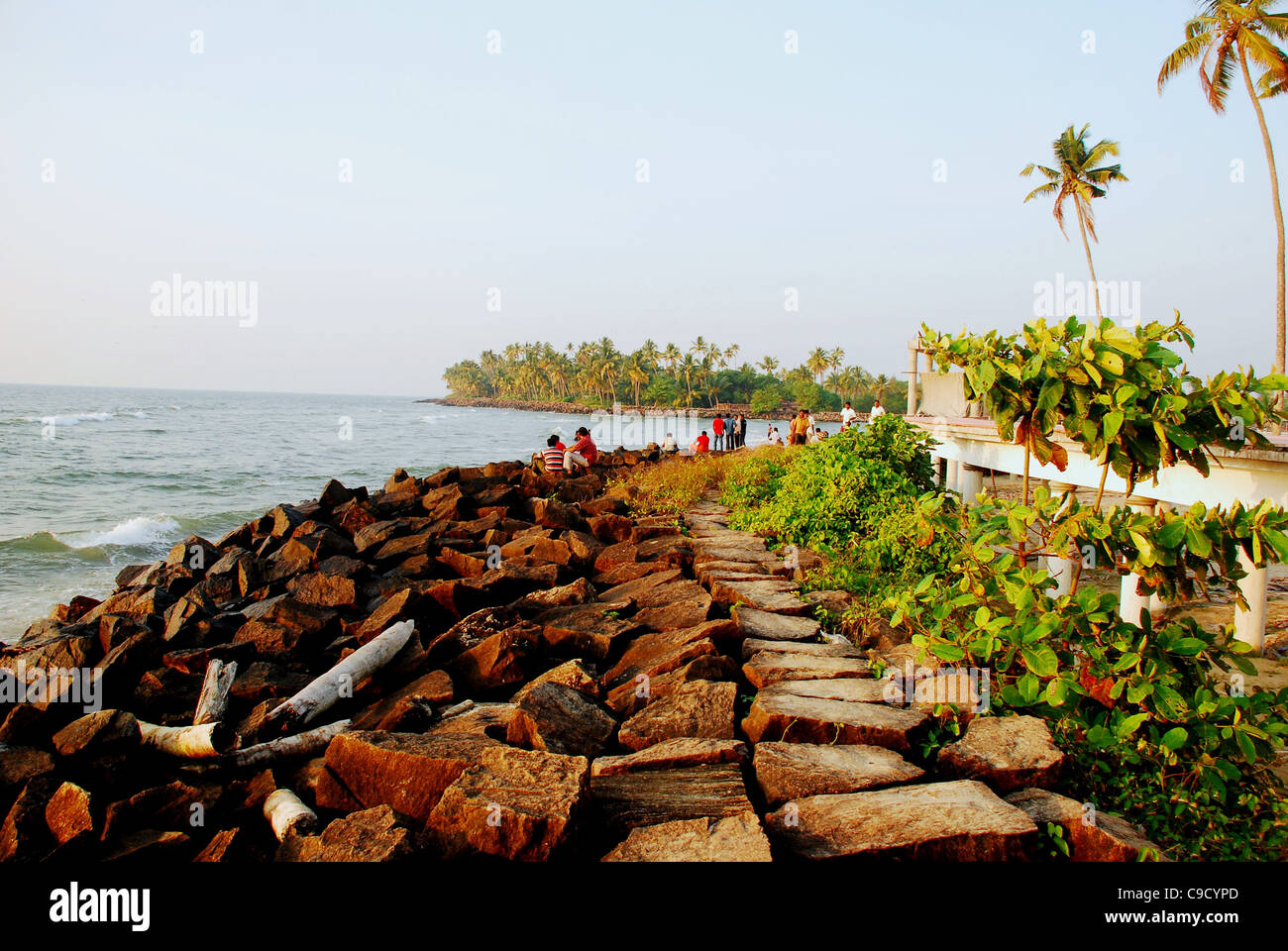 Rocks lined by a beach in Kerala Stock Photo - Alamy