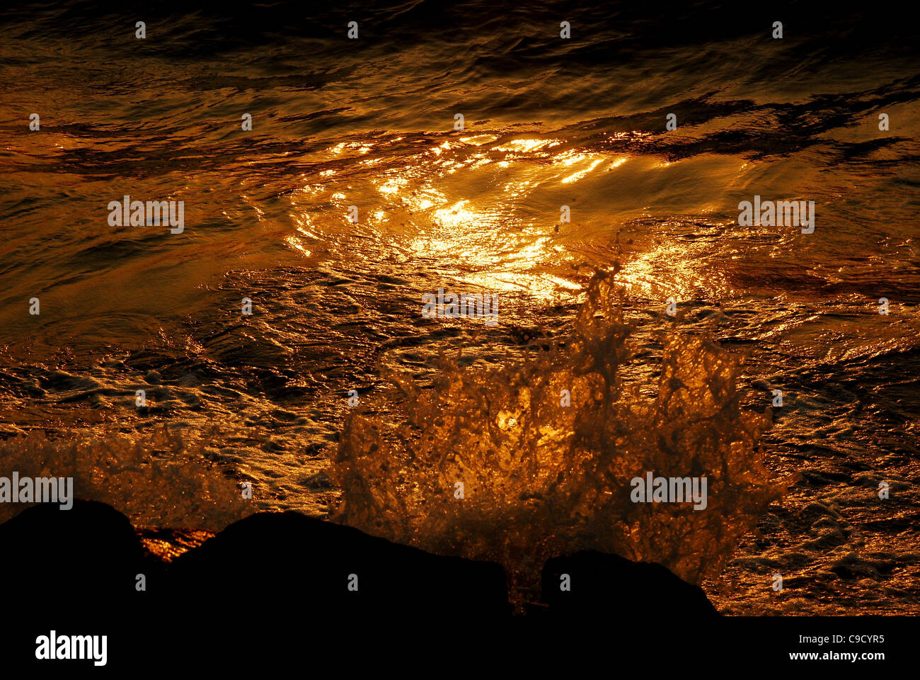 Waves hitting rocks Stock Photo - Alamy