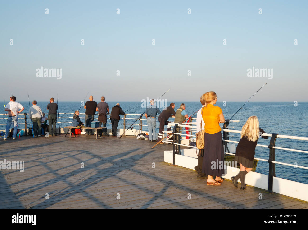 People fishing from the end of Saltburn pier on the north east coast ...