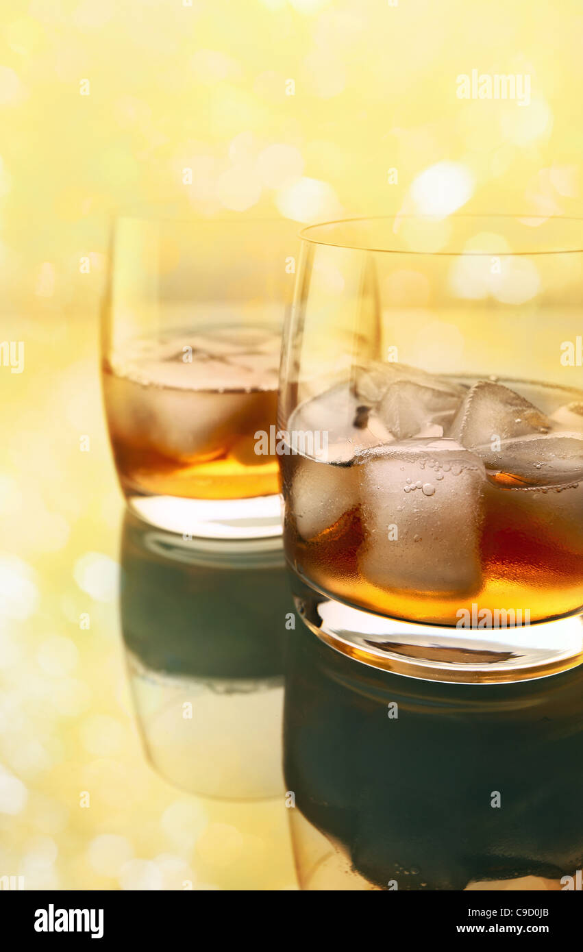 whisky with ice on a glass table Stock Photo - Alamy