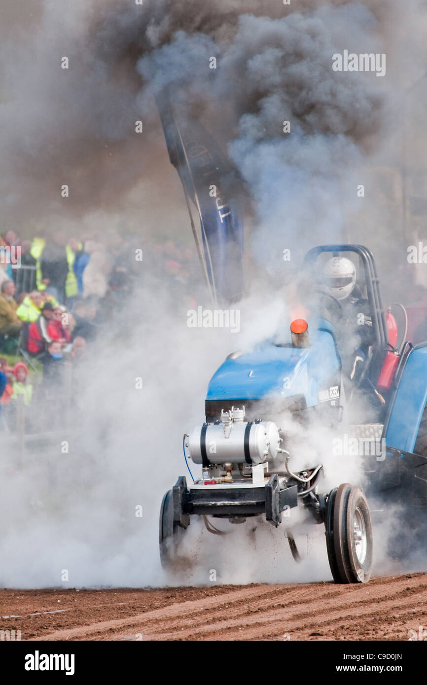 Smoke, steam and flame erupting from a competitor in a tractor pulling ...