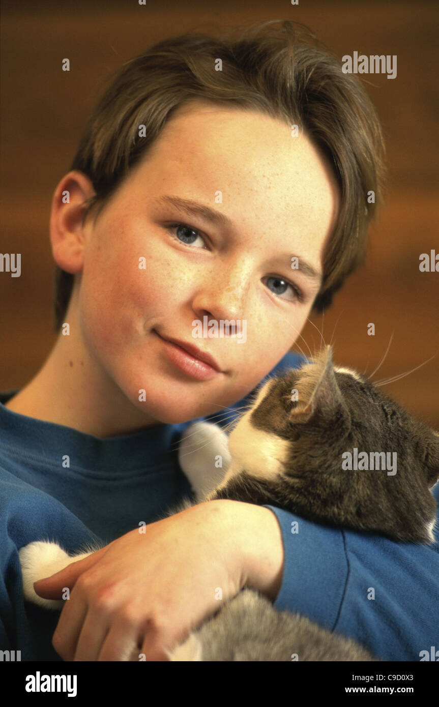 Portrait of a boy hugging a cat Stock Photo - Alamy