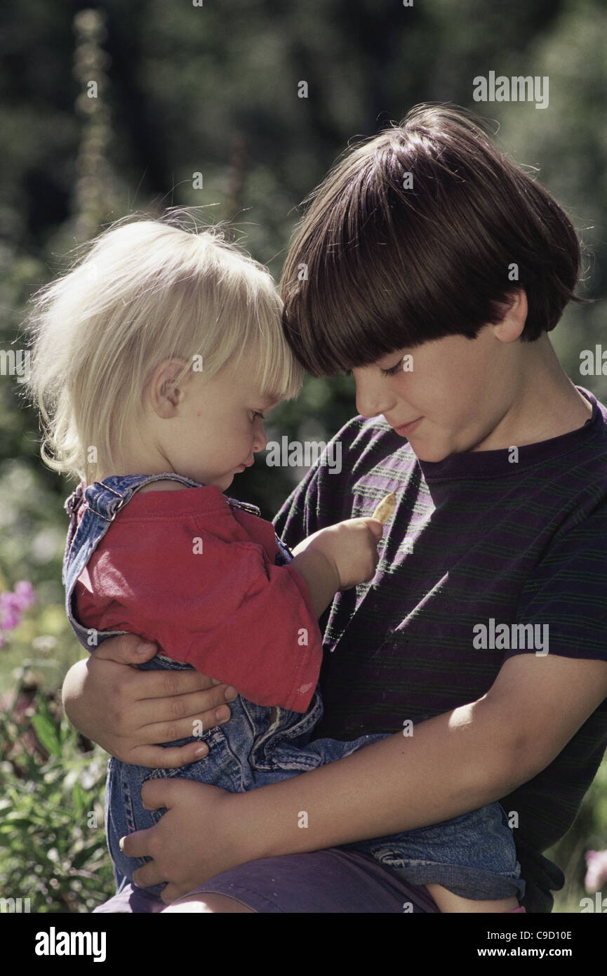 Girl carrying baby sibling hi-res stock photography and images - Alamy