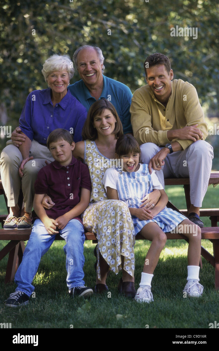 Portrait of a three generation family in a park Stock Photo - Alamy